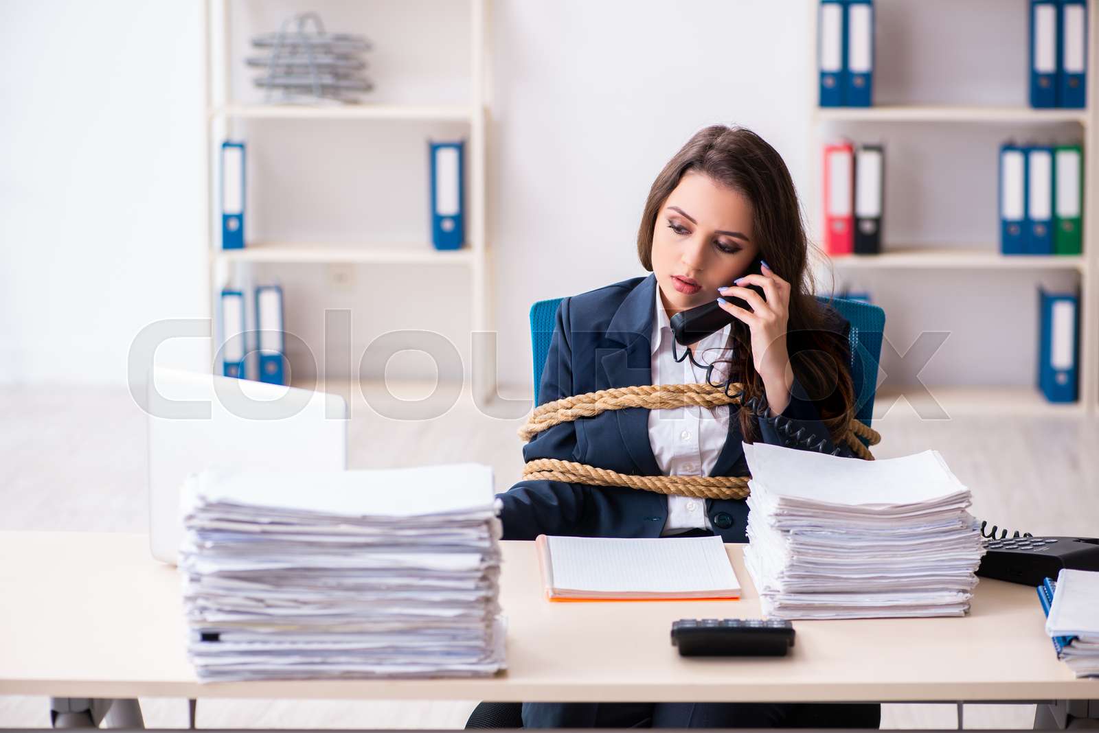 Young beautiful employee tied up with rope in the office | Stock image ...