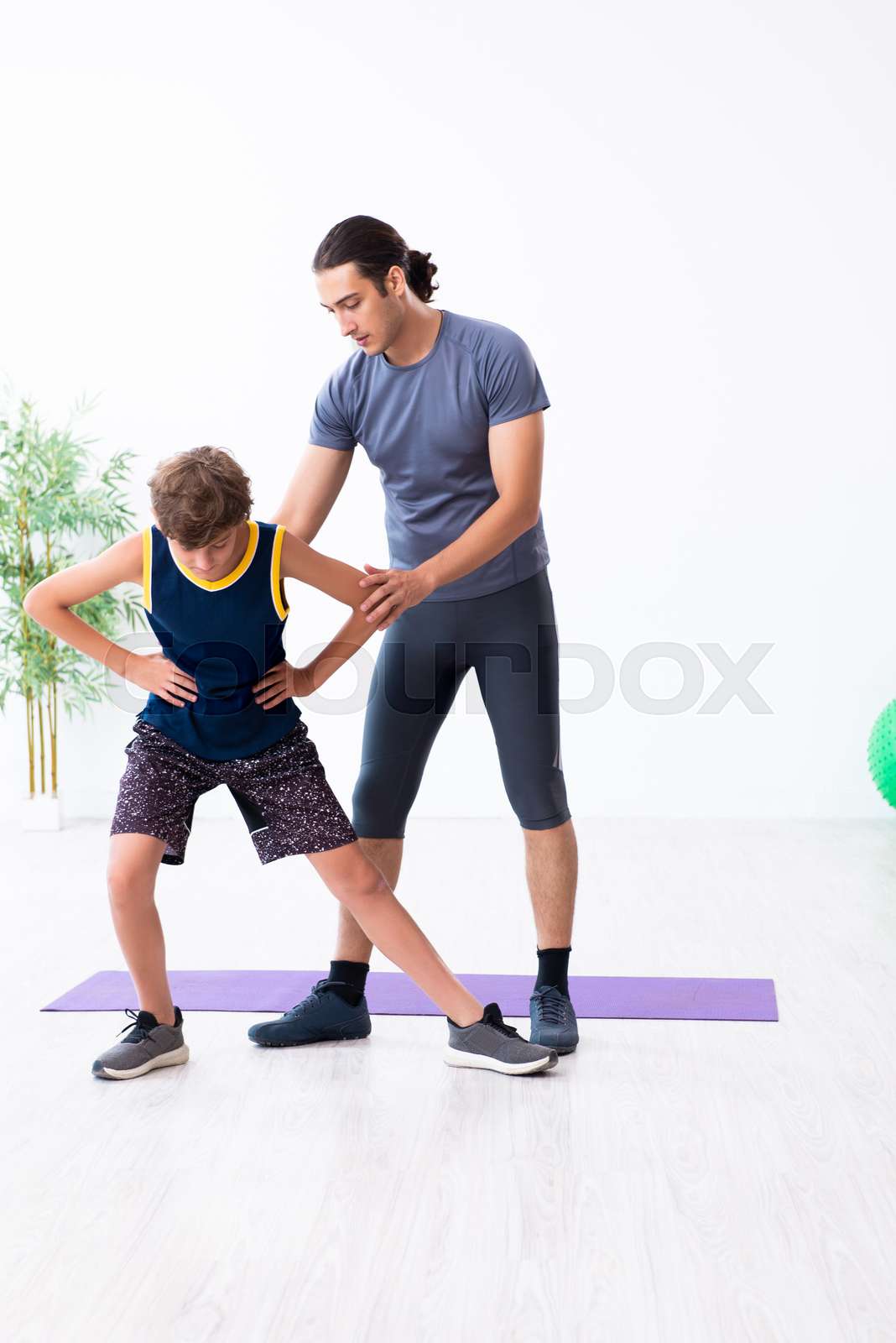 Young father and his son doing exercises | Stock image | Colourbox