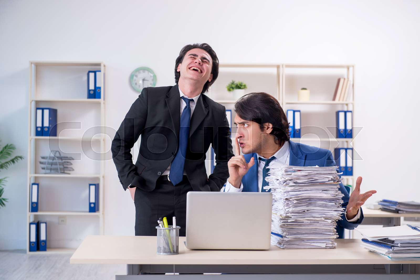 Two male colleagues unhappy with excessive work | Stock image | Colourbox