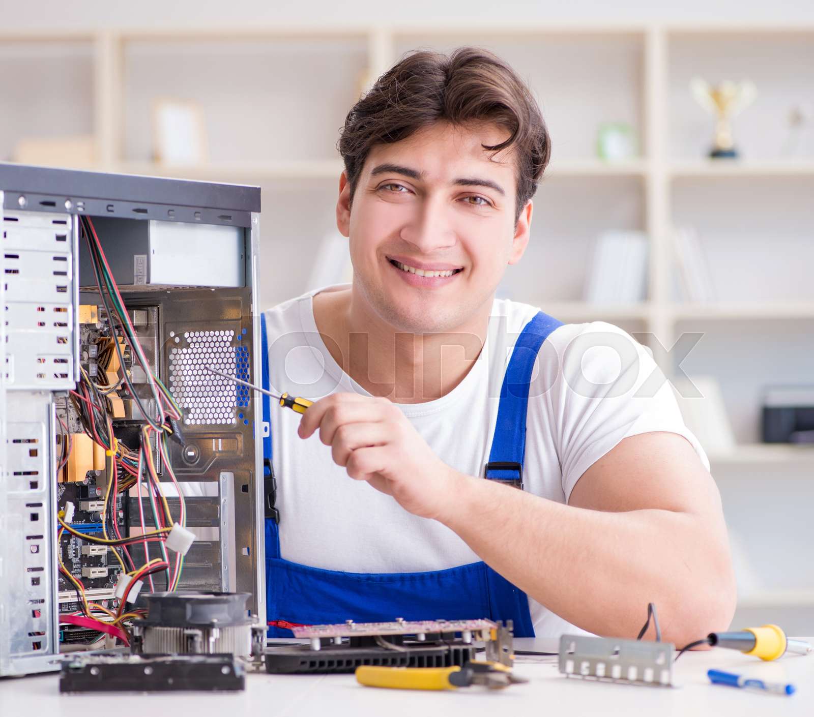 Computer repairman repairing desktop computer | Stock image | Colourbox