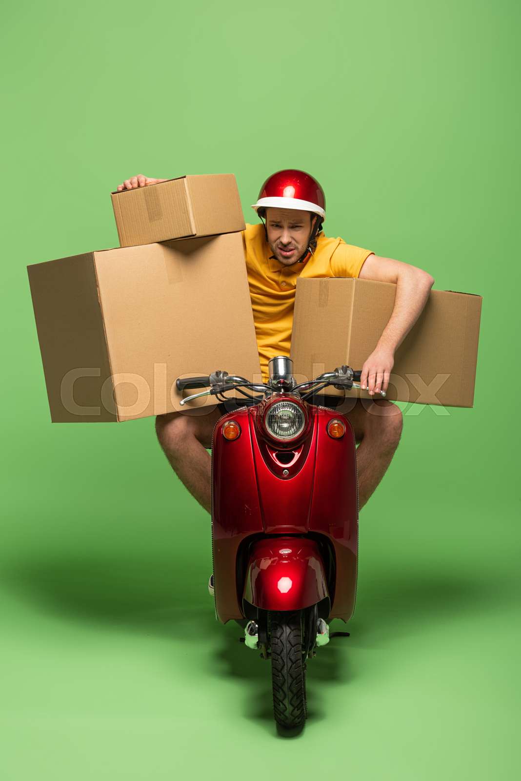 tired delivery man in yellow uniform on scooter with boxes on green ...