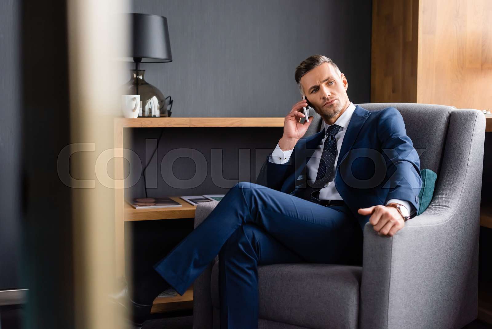selective focus of businessman in suit talking on smartphone | Stock ...