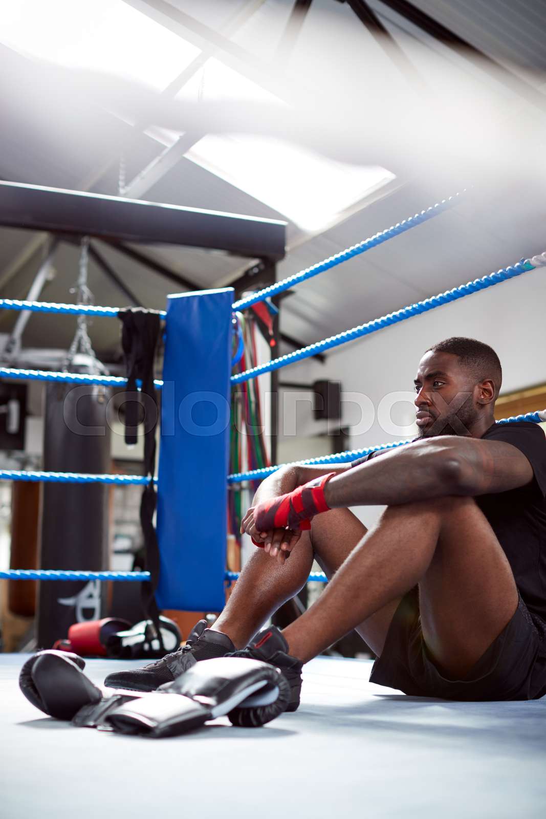Tired Male Boxer Sitting In Boxing Ring In Gym After Training Session ...