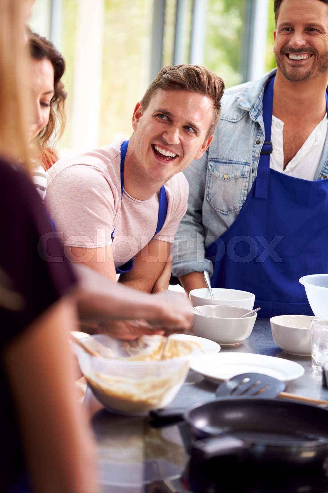 Students Watching Female Teacher Mixing Ingredients In Cookery Class ...