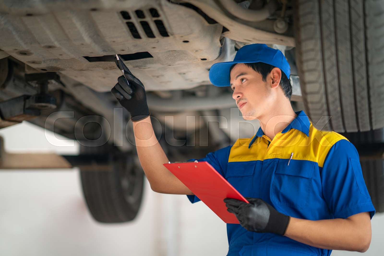 Asian man in car service | Stock image | Colourbox