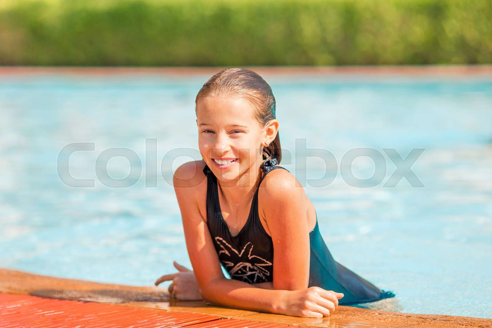 Little adorable girl in outdoor swimming pool | Stock image | Colourbox