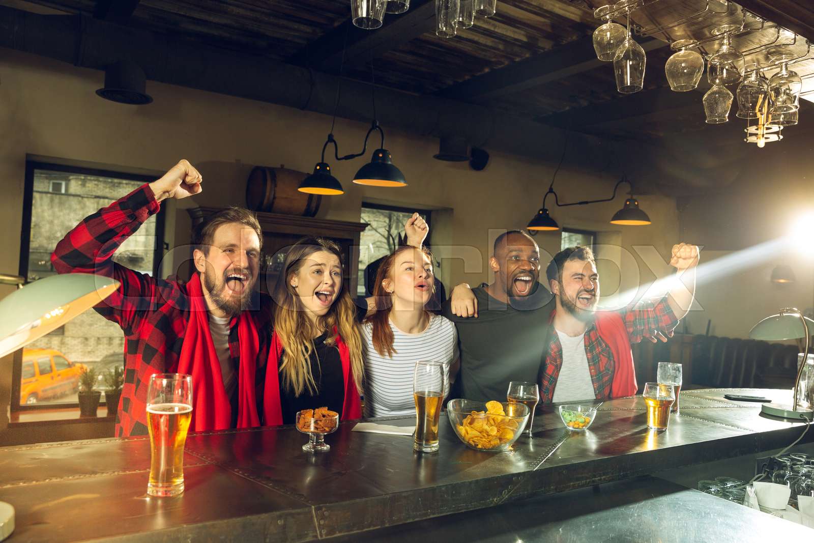 Sport fans cheering at bar, pub and drinking beer while championship ...