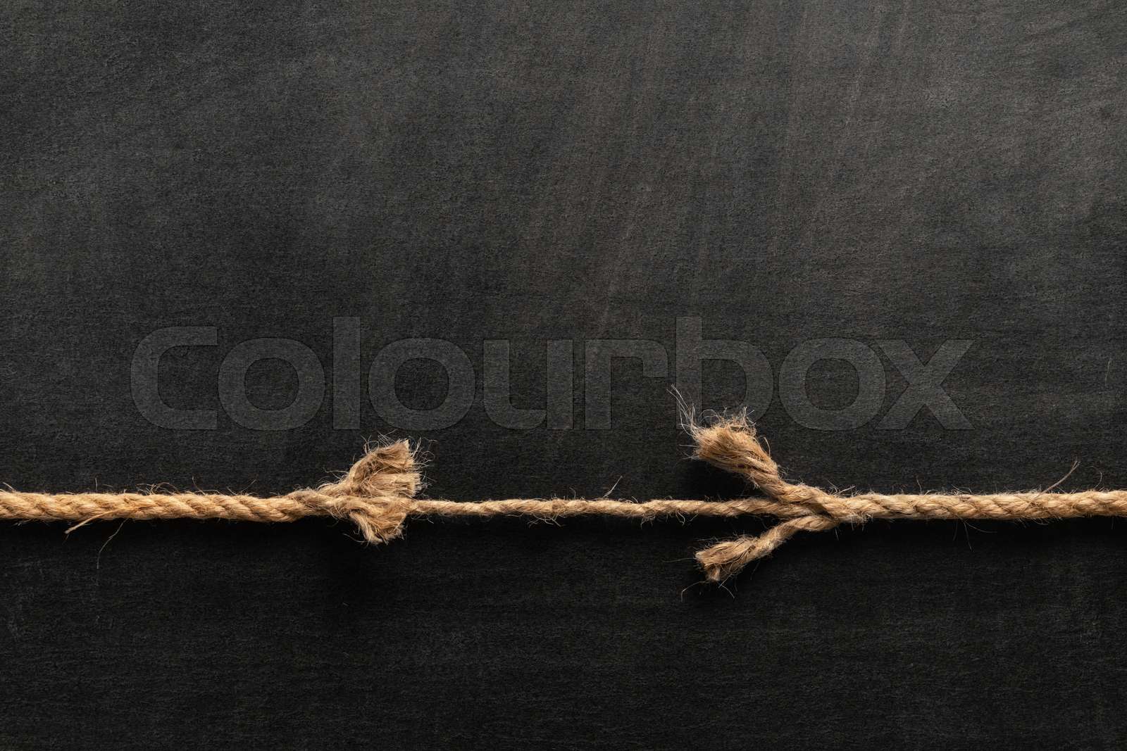 Long, old frayed rope is breaking off. Isolated on black. | Stock image ...