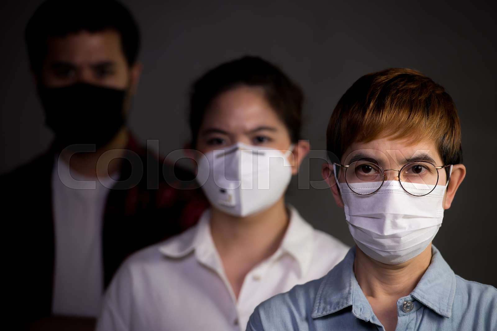 People wearing surgical masks | Stock image | Colourbox
