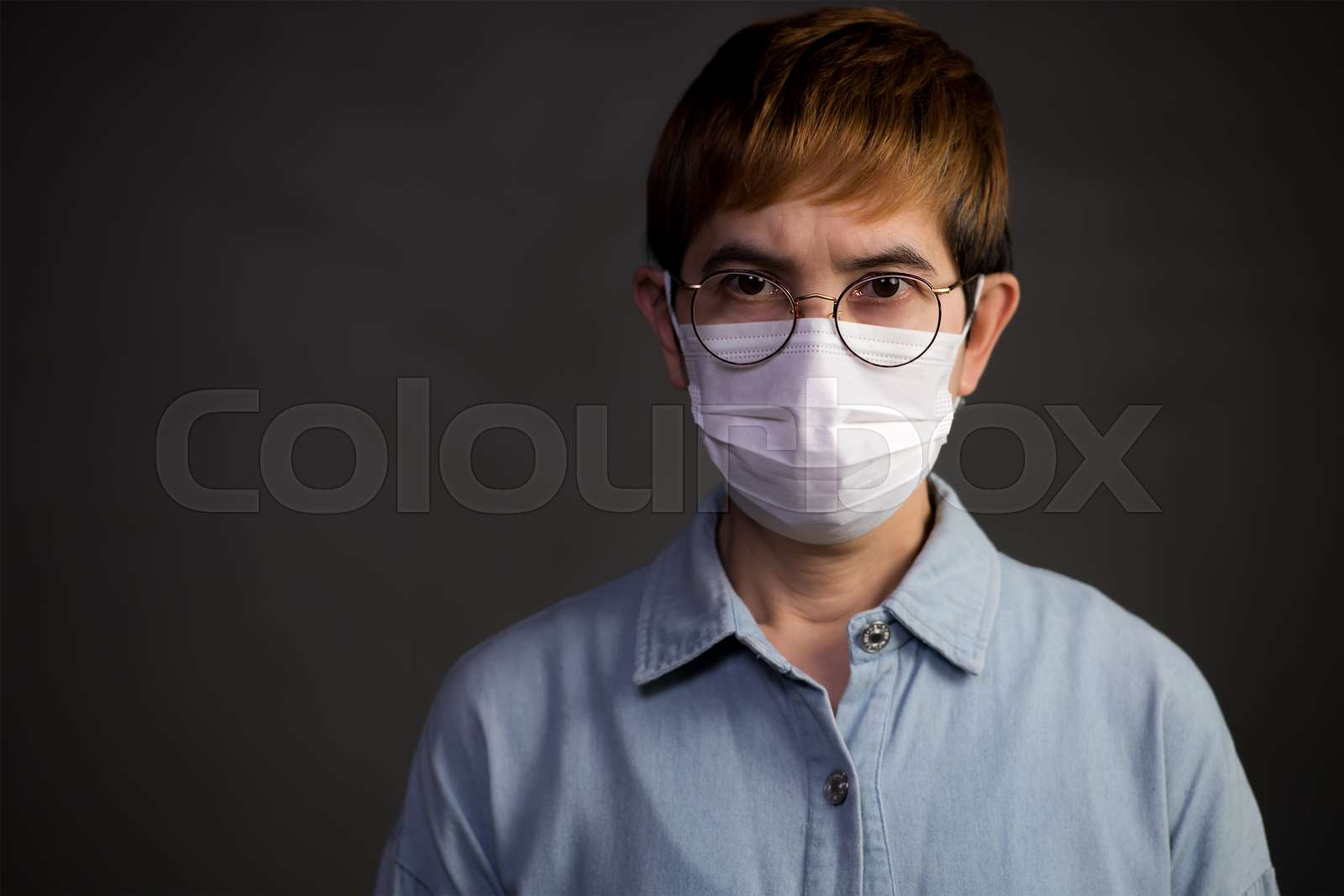 Person wearing surgical mask | Stock image | Colourbox