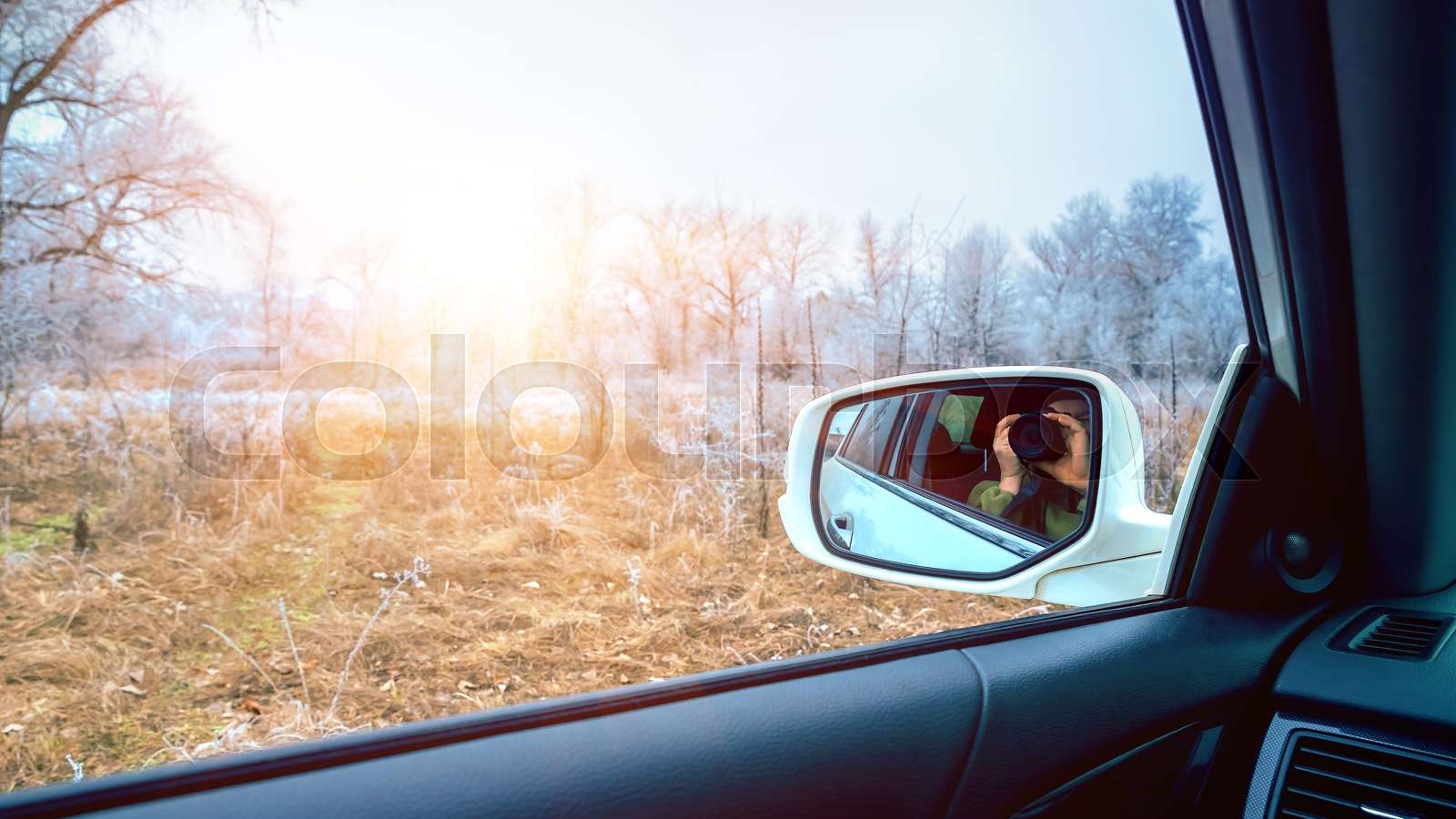 Car mirror with reflection of photographer on nature background ...