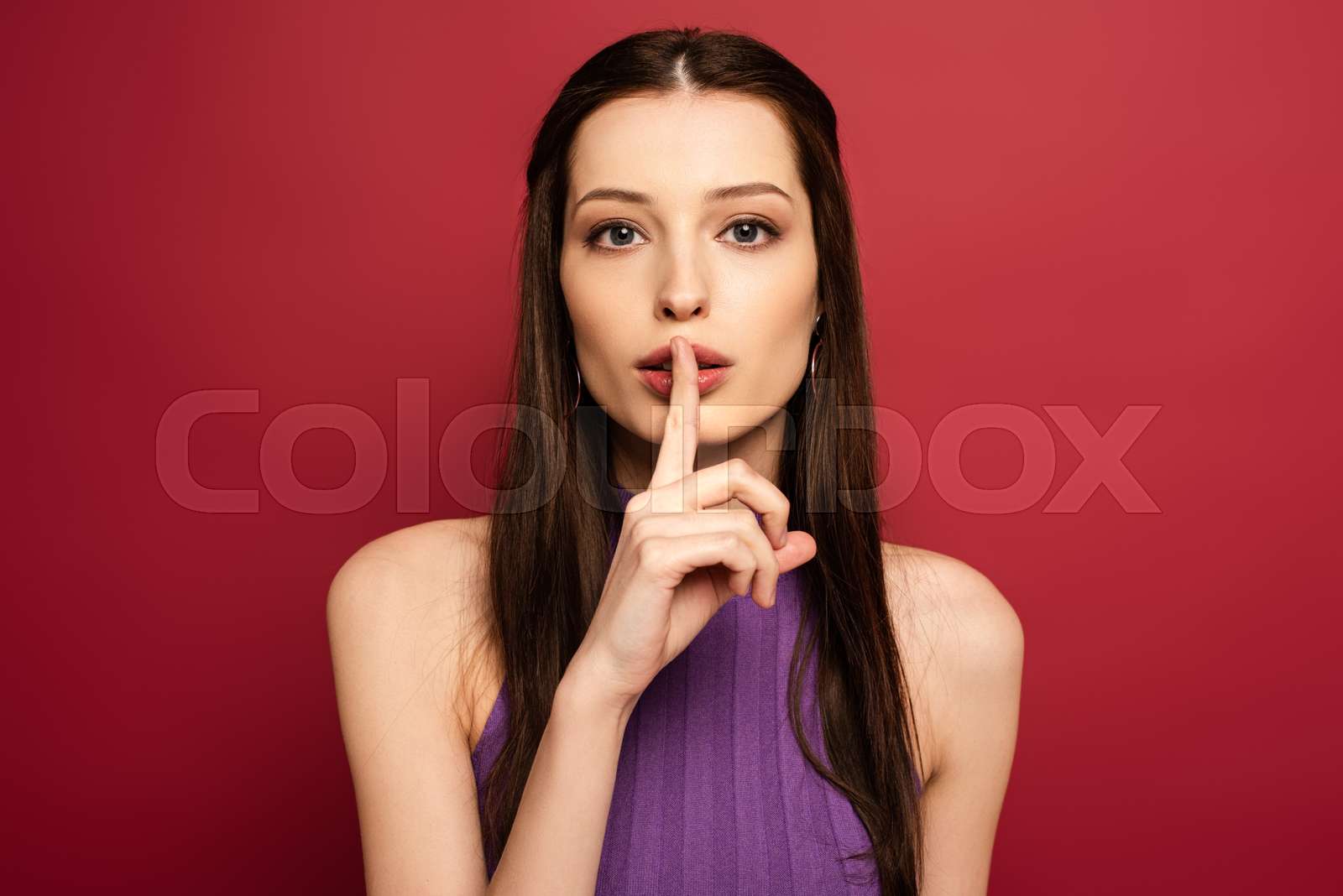 portrait of beautiful woman showing silence symbol on red | Stock image ...