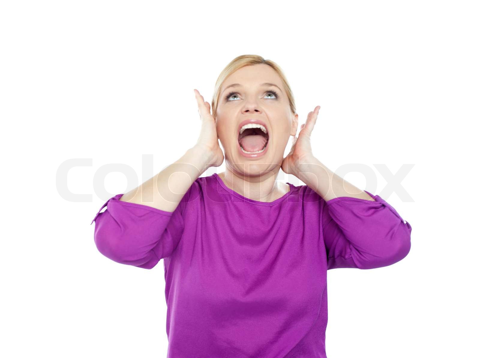 Woman shouting with hands on ears | Stock image | Colourbox