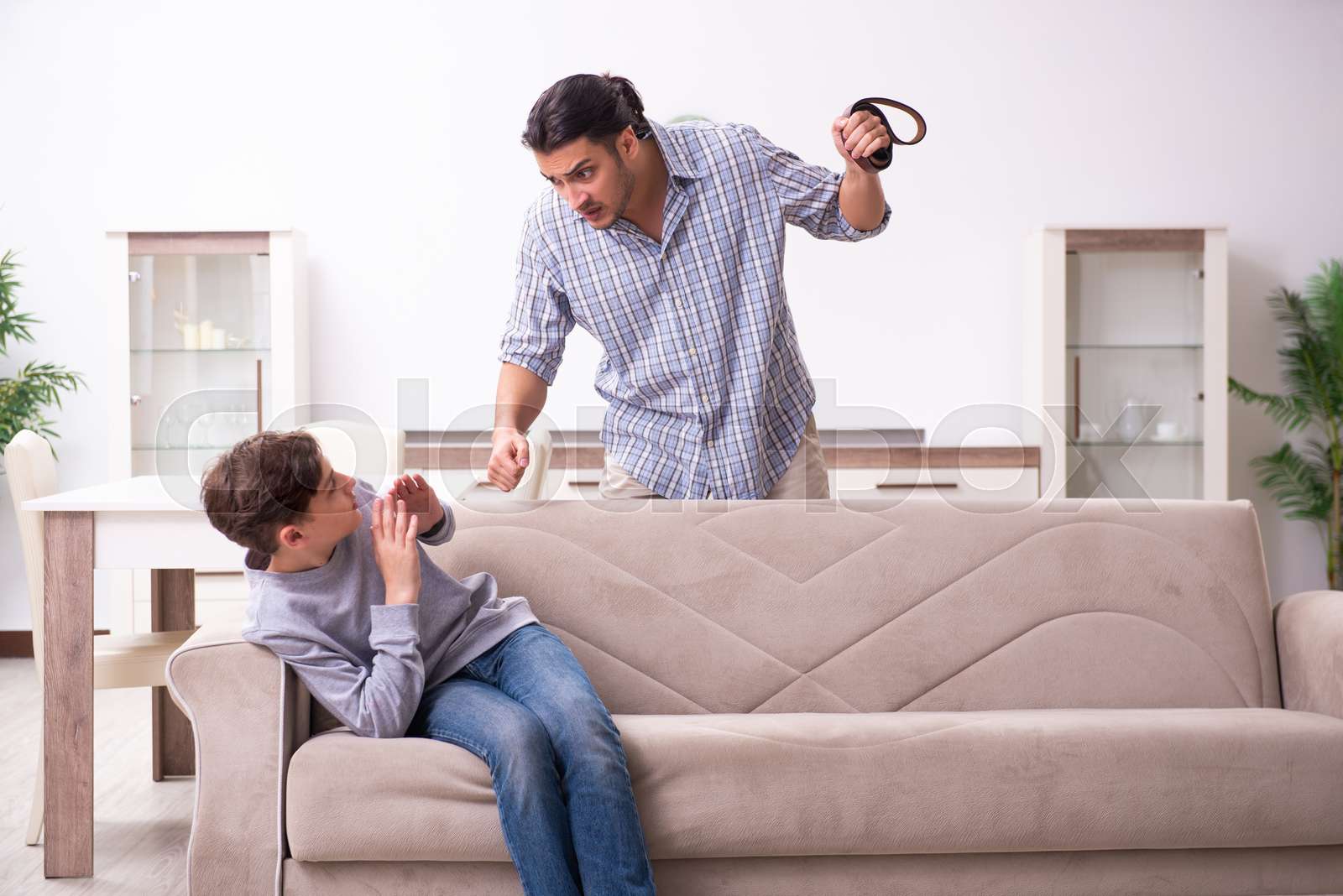 Father beating and punishing his sone | Stock image | Colourbox