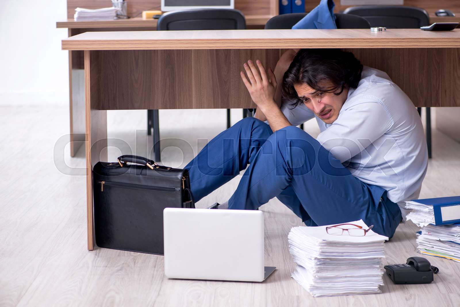 Young male employee and too many work in the office | Stock image ...