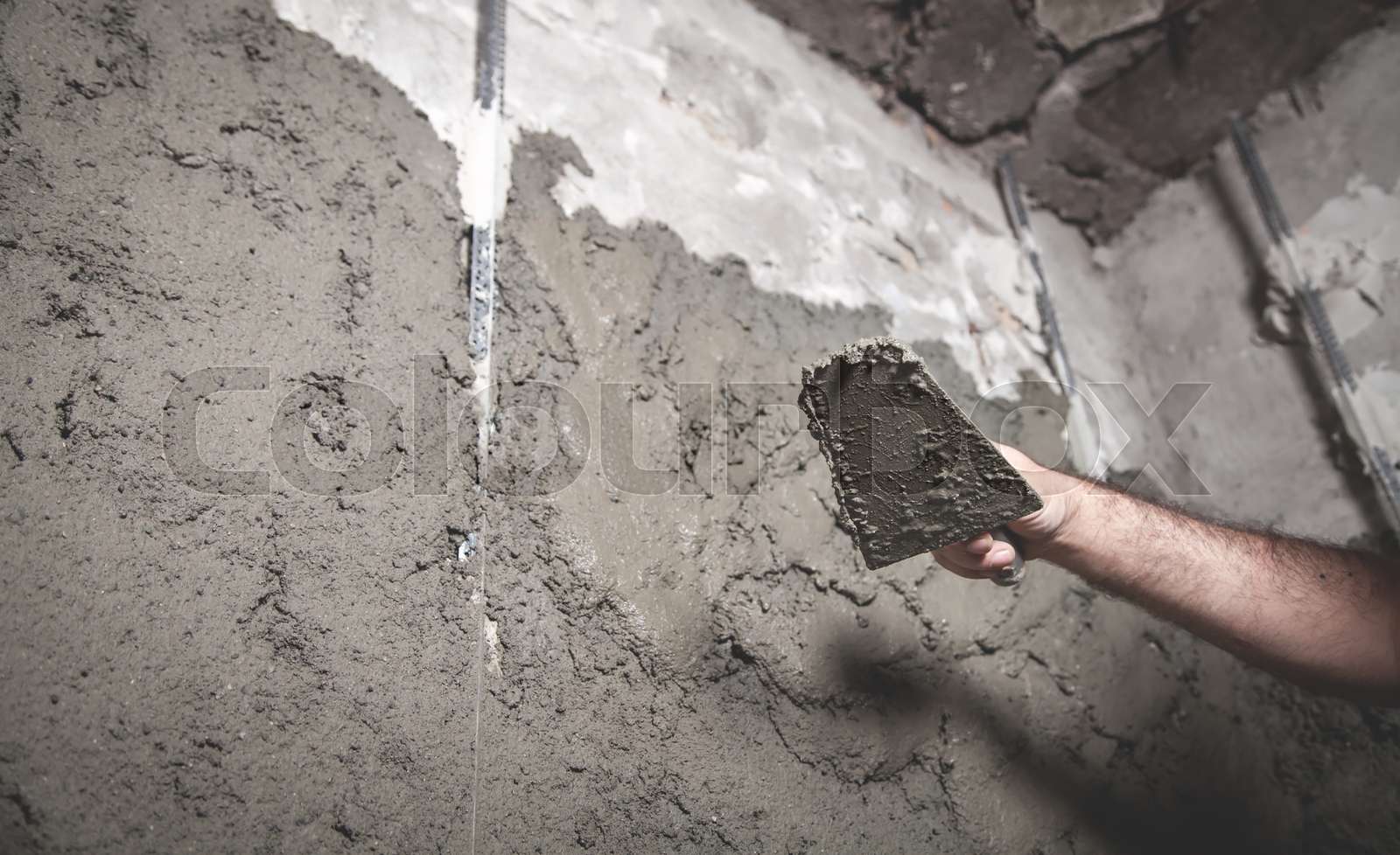 Worker plastering wall. Construction work | Stock image | Colourbox