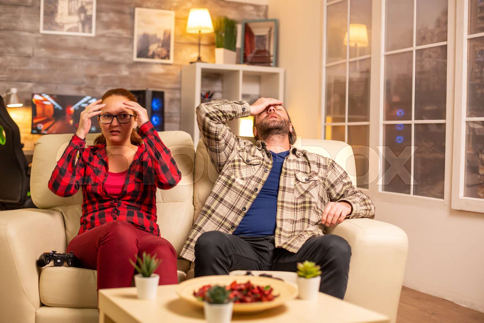 Angry and frustrated gamers losing while playing video games | Stock ...