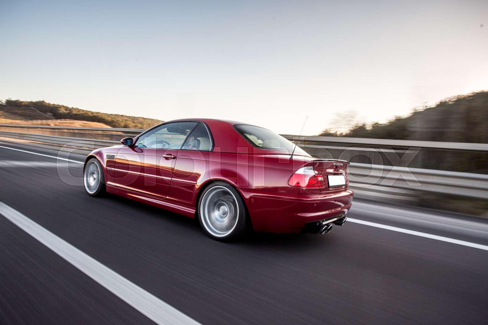 Red sedan car driving on the highway under the sunlight | Stock image ...