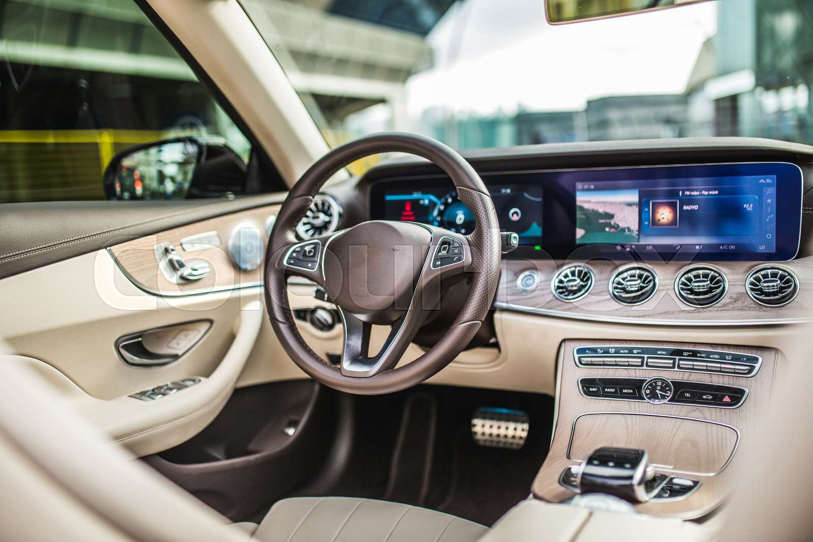 Car interior, driver seat, navigation, speed and fuel meters and AC ...