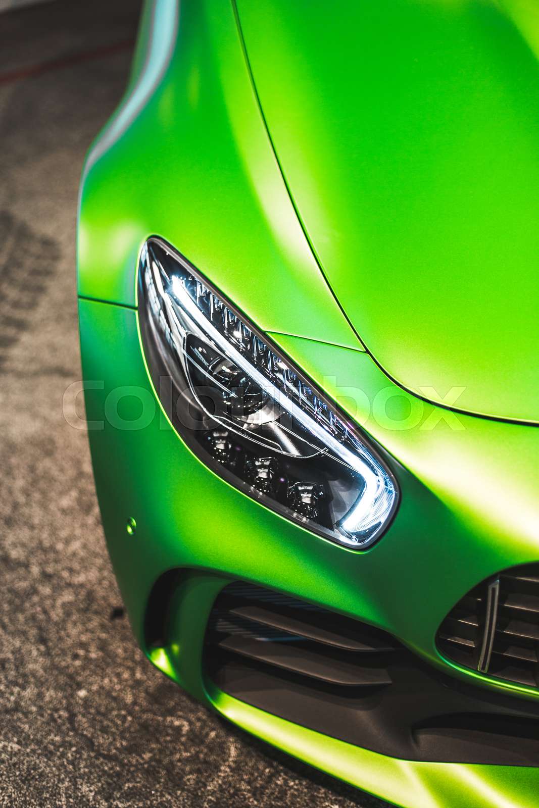 Front bumper and light of a green car | Stock image | Colourbox