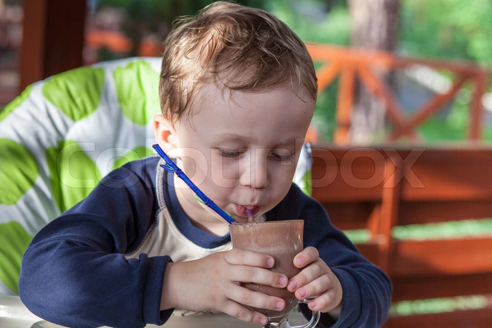 Kid drinking a chocolate cocktail | Stock image | Colourbox