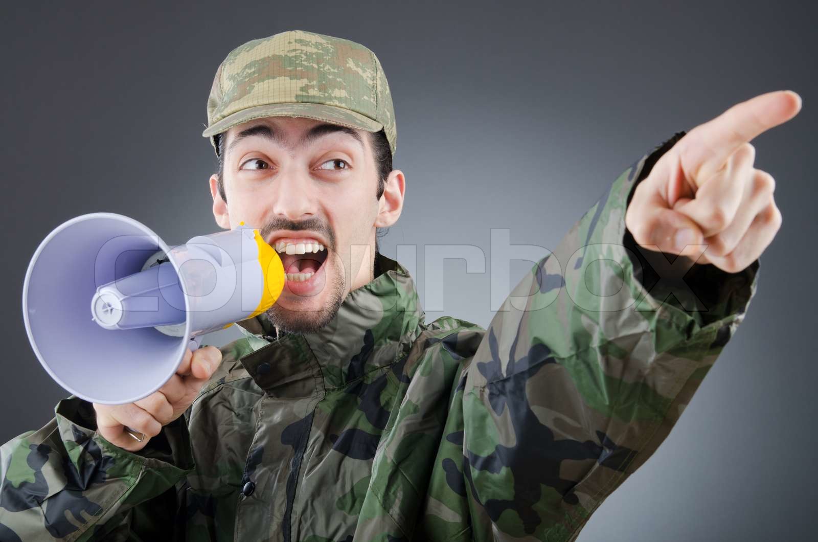 Soldier with loudspeaker shouting | Stock image | Colourbox