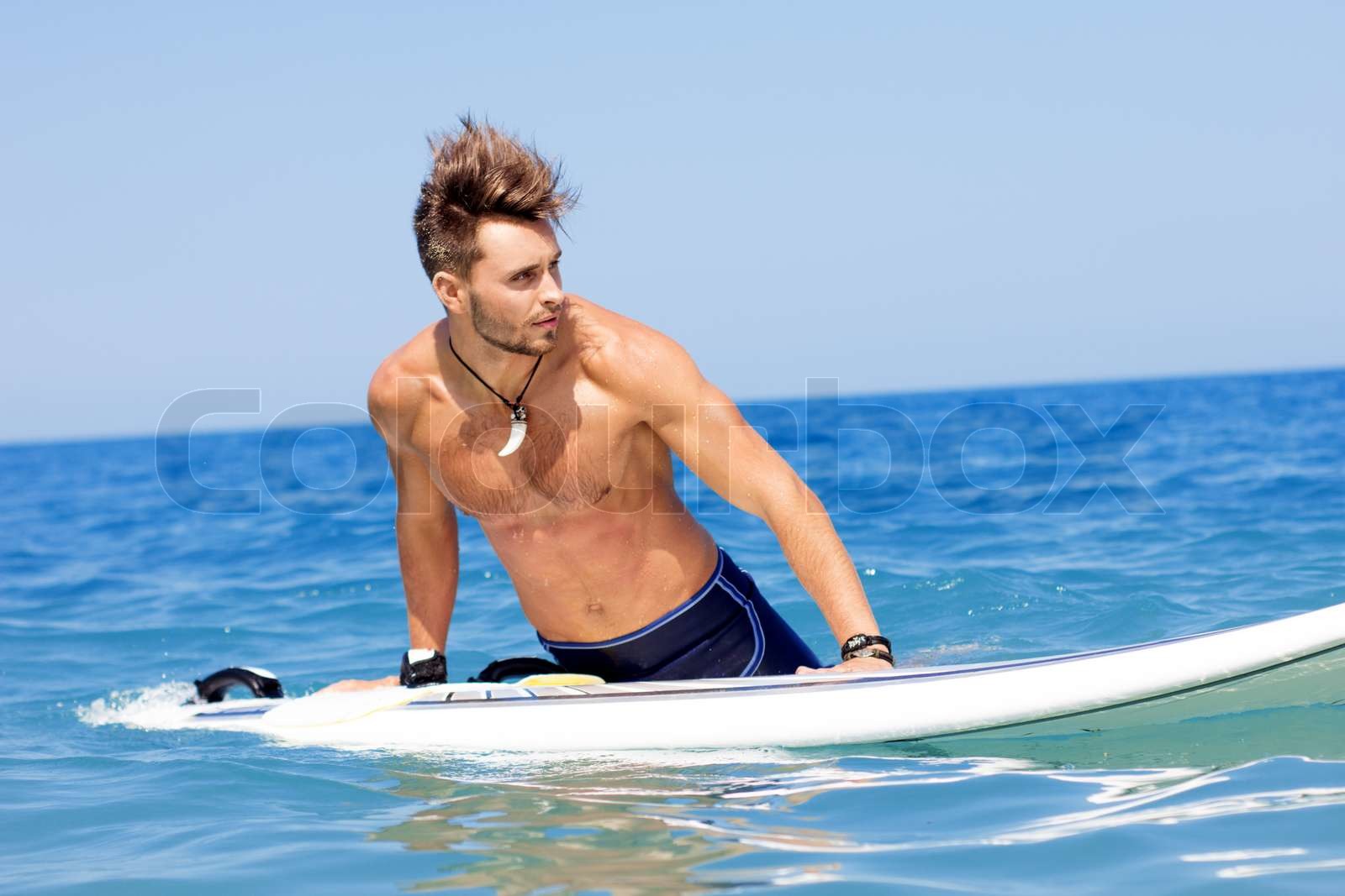 Strong young surf man portrait at the beach with a surfboard | Stock ...