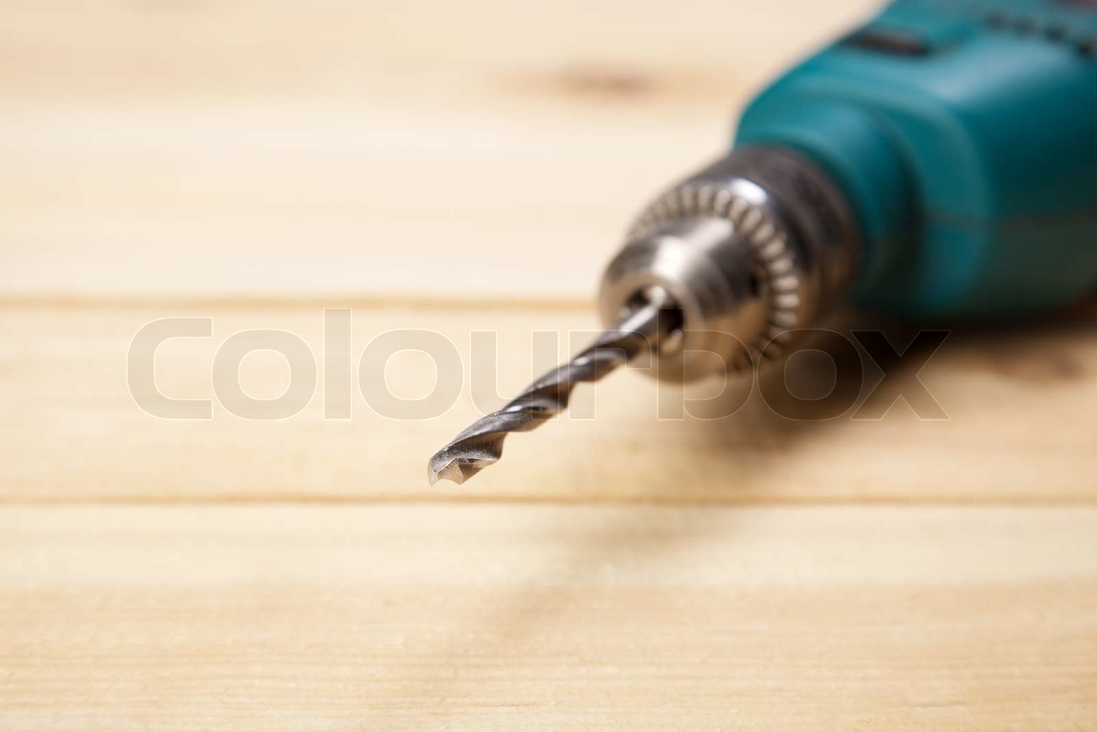 Drill on pine desks | Stock image | Colourbox