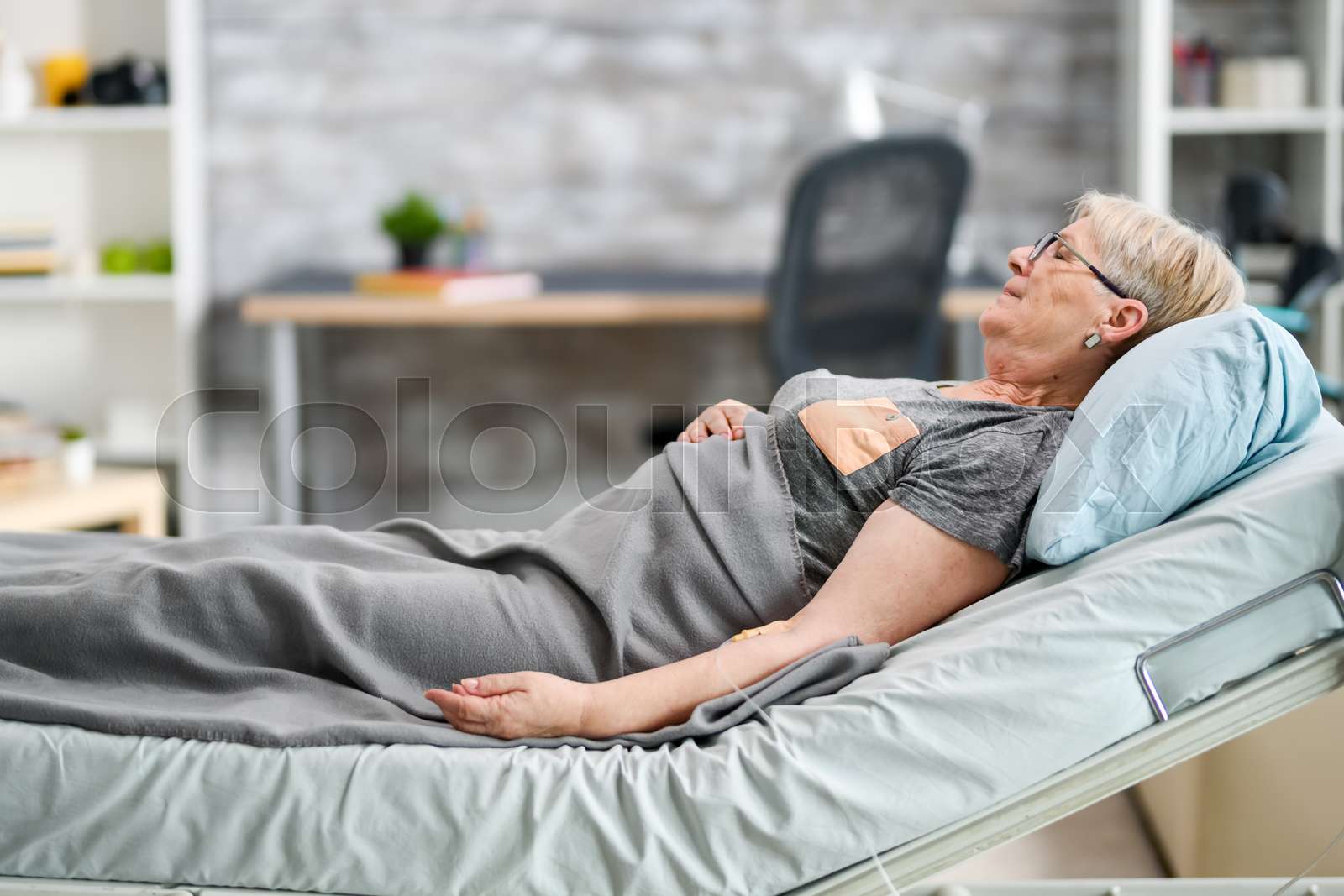 Old granny sleeping in a modern nursing home room. | Stock image ...