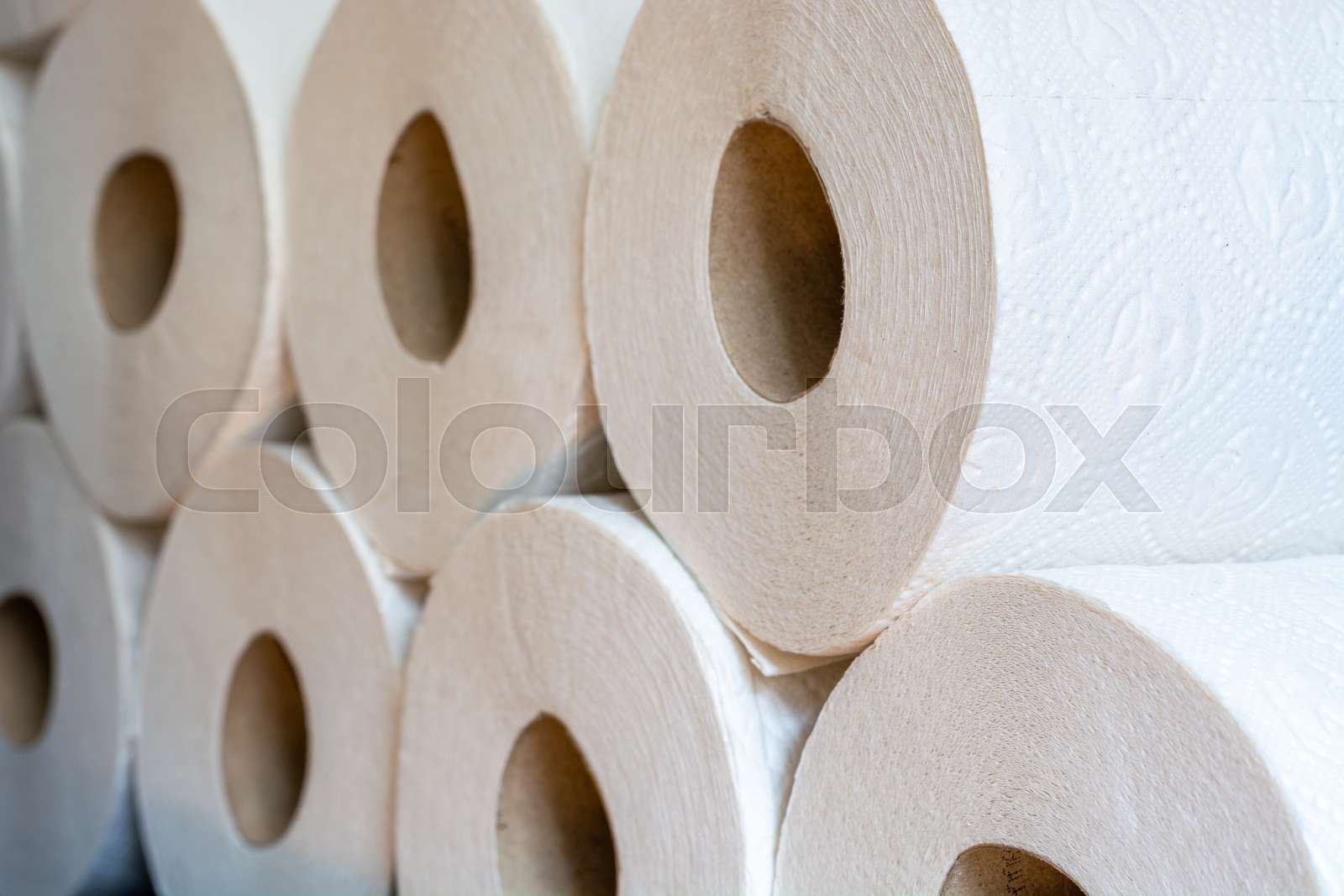 Piled up toilet paper rolls close up from the side | Stock image ...