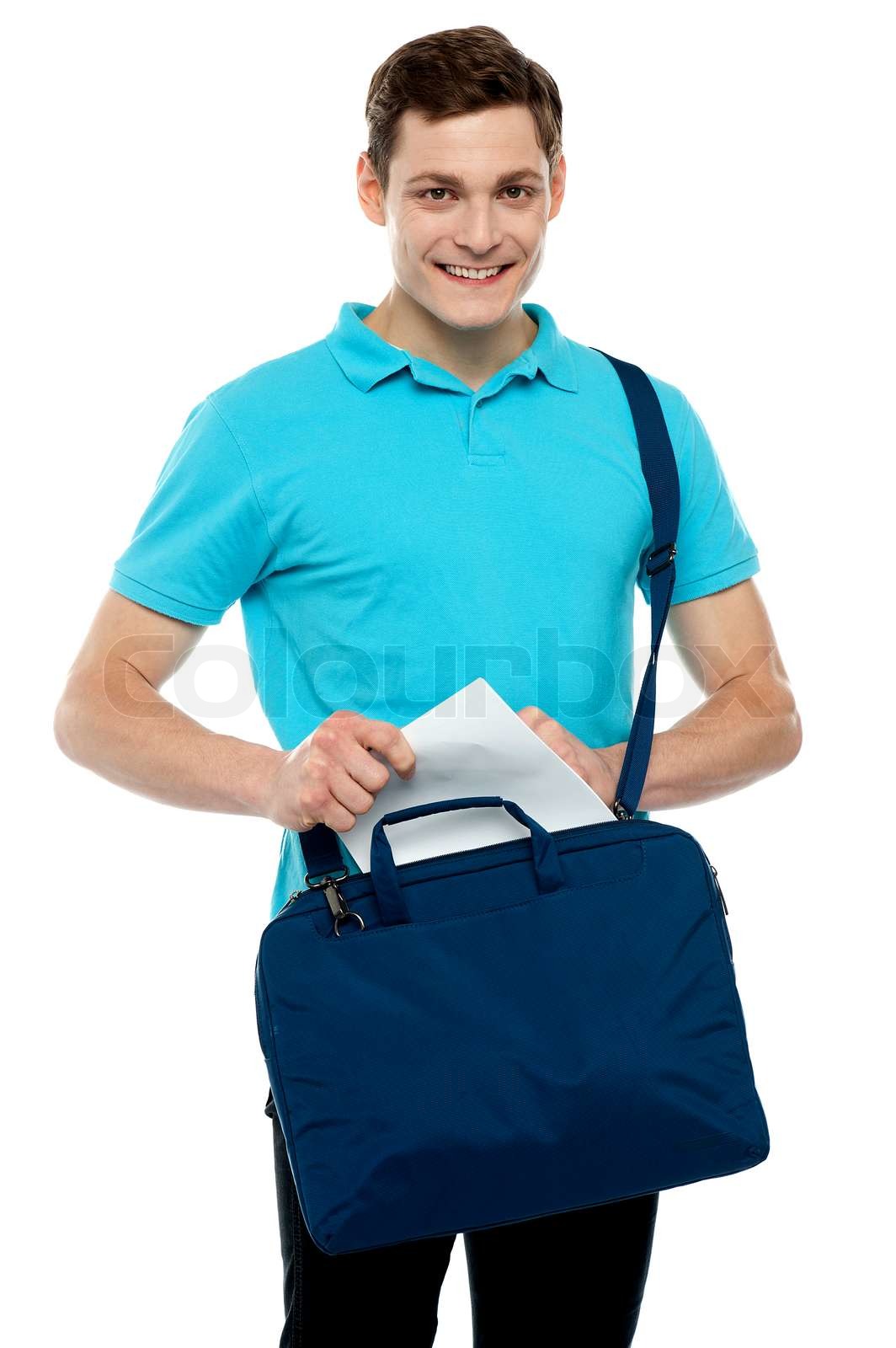 Guy taking out paper from his laptop bag | Stock image | Colourbox