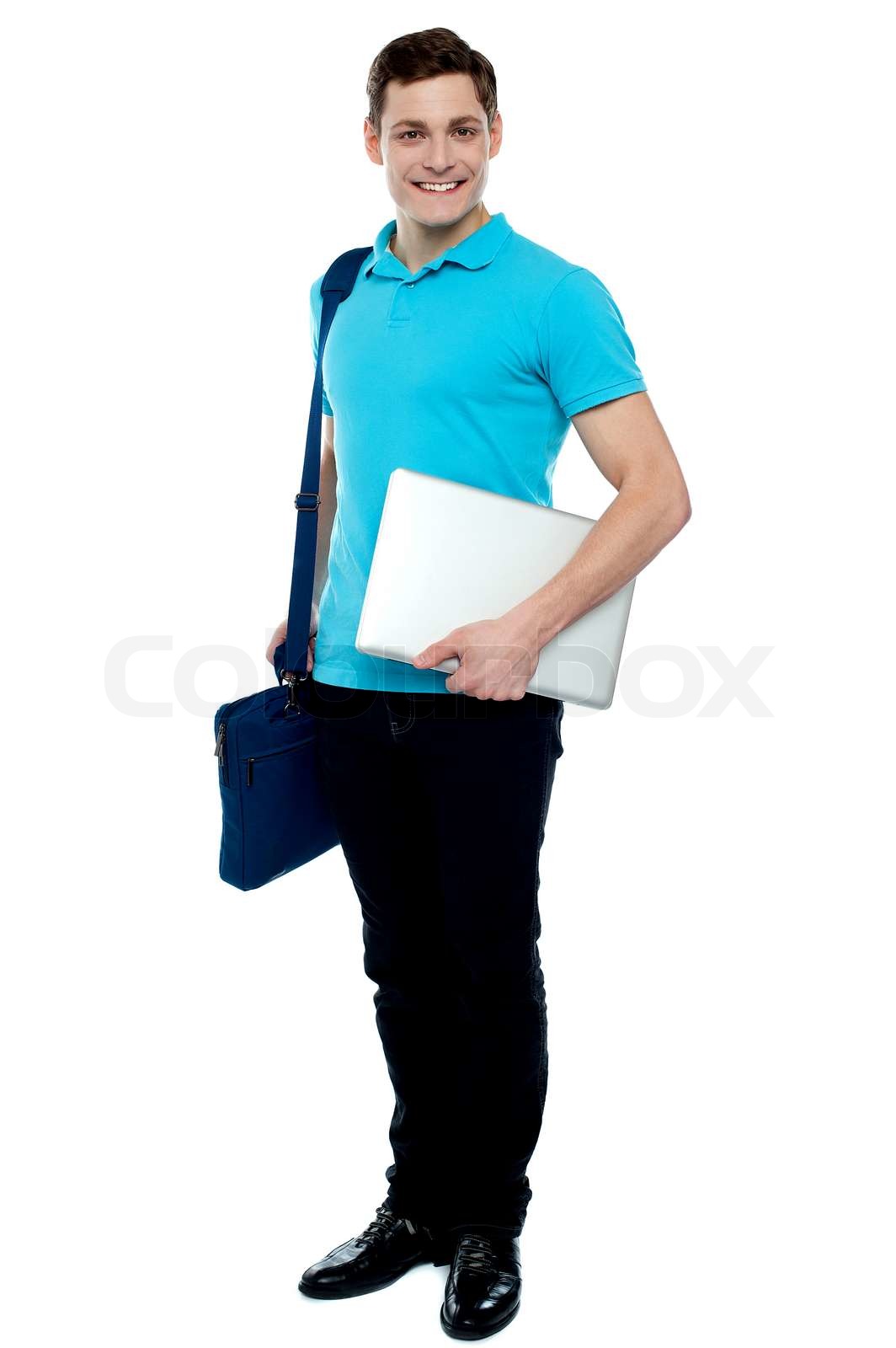 Cheerful man carrying laptop, off to work | Stock image | Colourbox