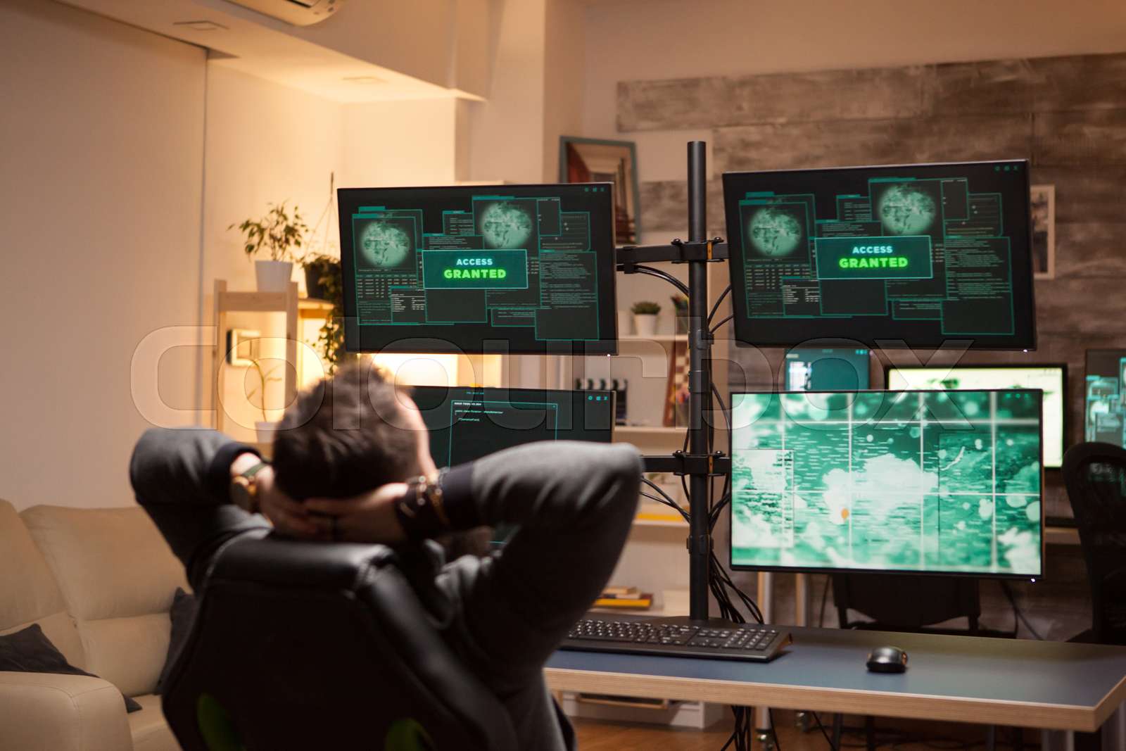 Happy hacker after a cyber attack using a dangerous malware | Stock image | Colourbox