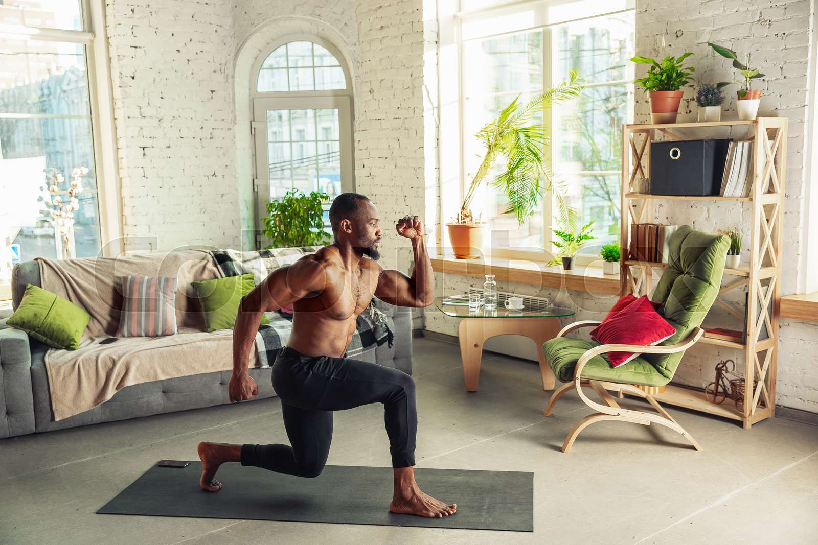 Young african-american man teaching at home online courses of fitness ...