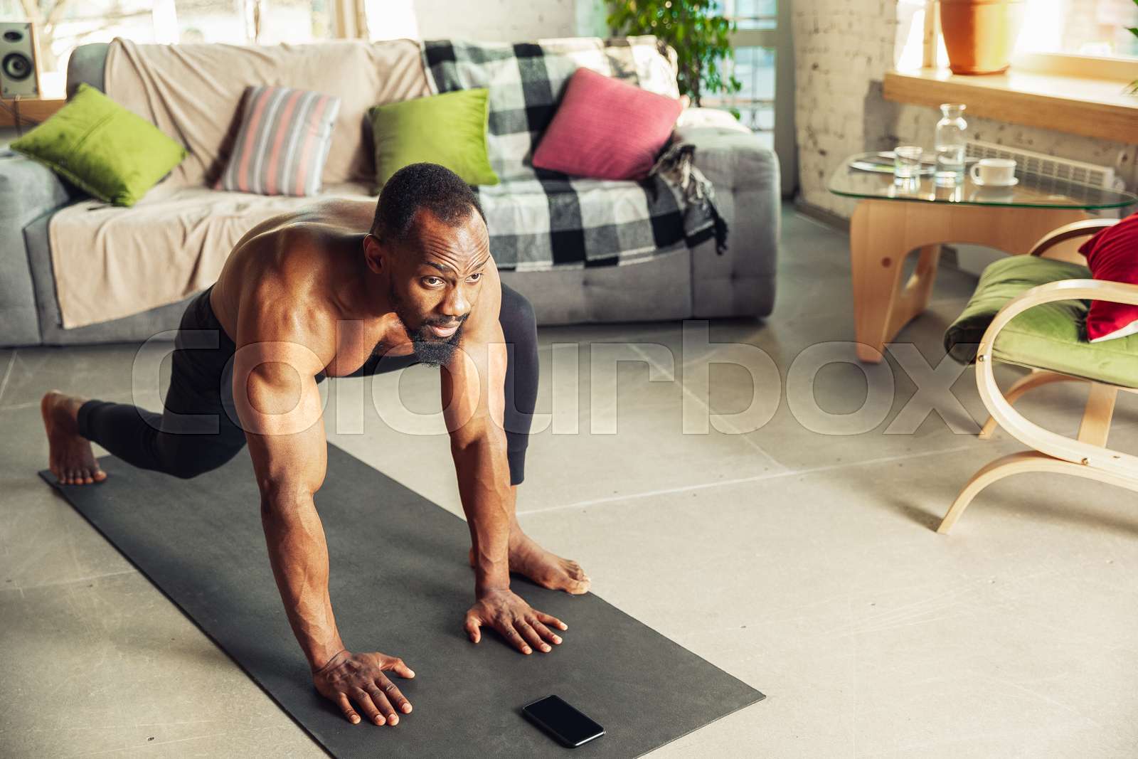 Young african-american man teaching at home online courses of fitness ...