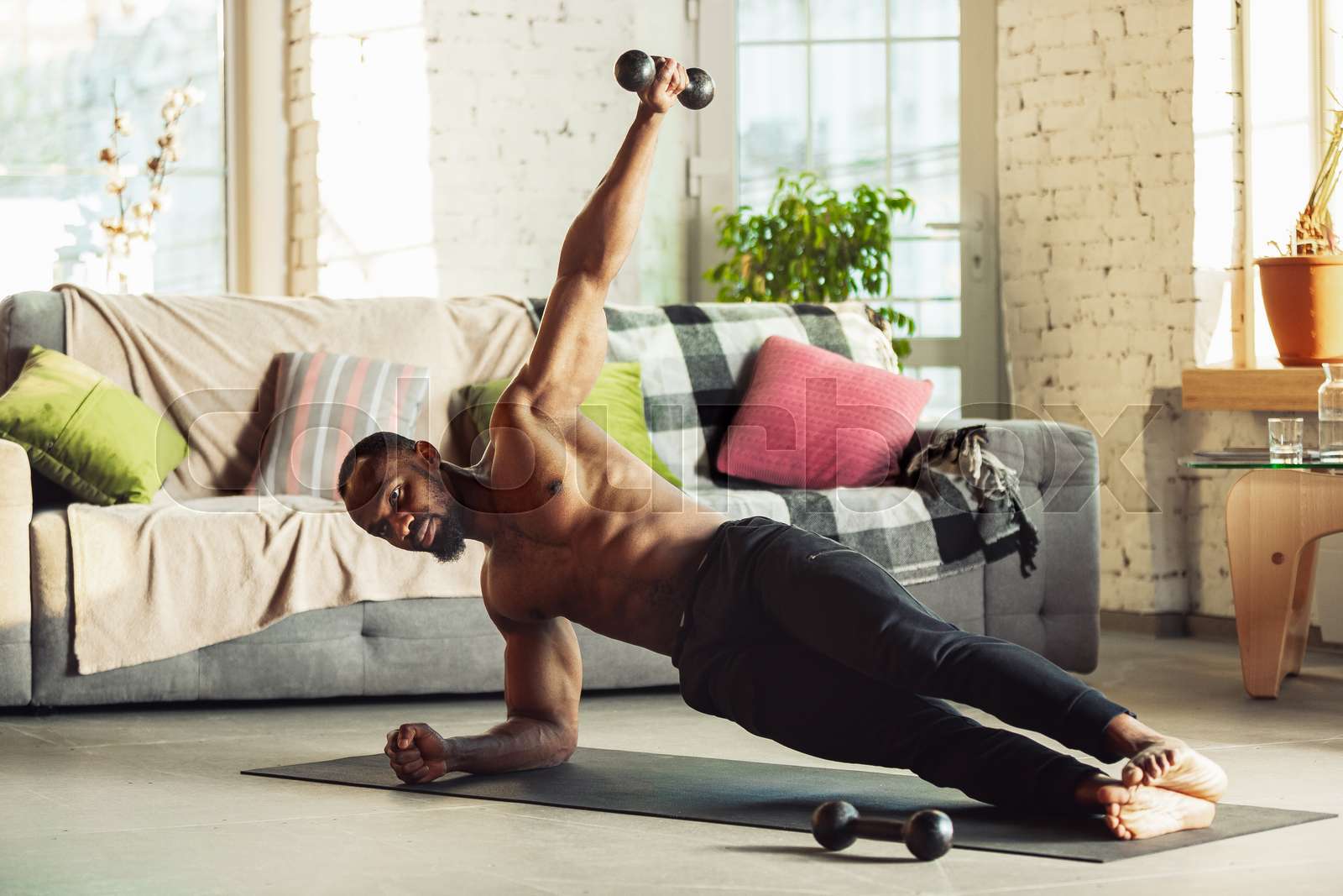 Young african-american man teaching at home online courses of fitness ...