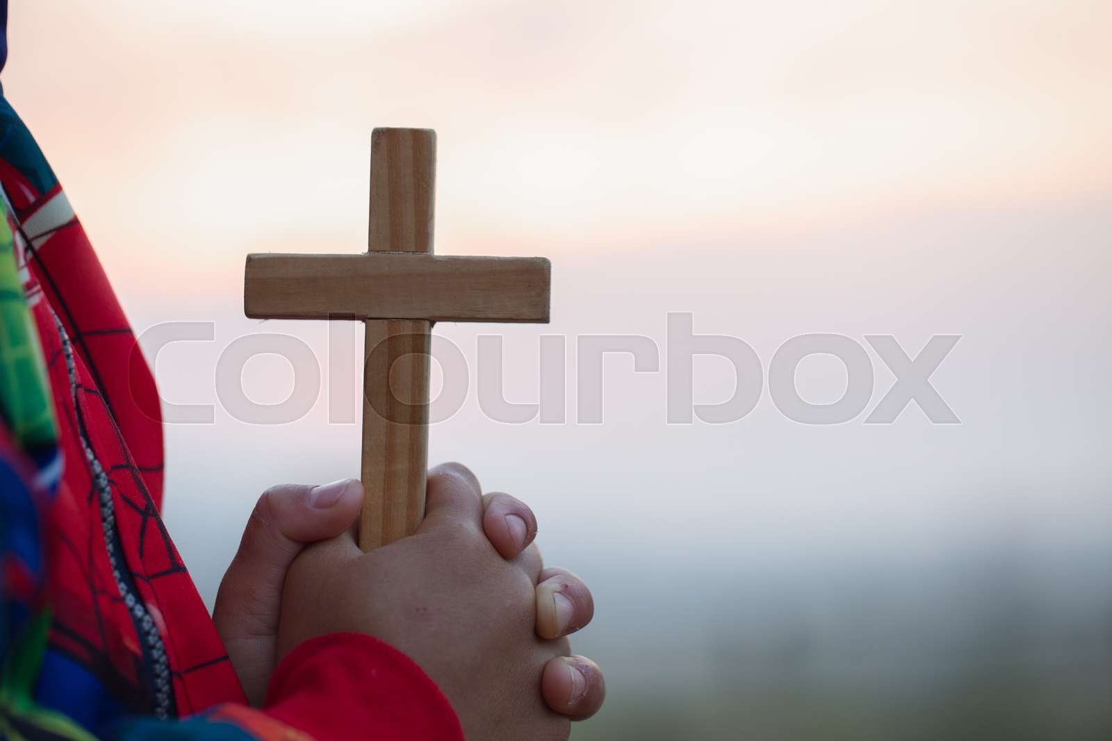 Boy hands holding a holy cross and praying to God, Child Praying for ...