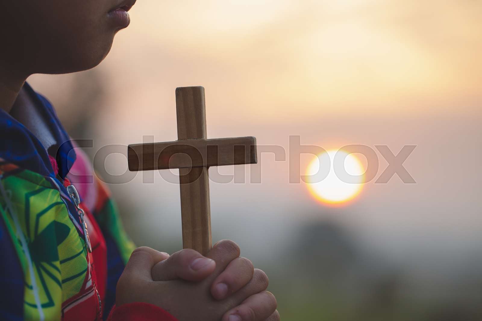 Boy hands holding a holy cross and praying to God, Child Praying for ...