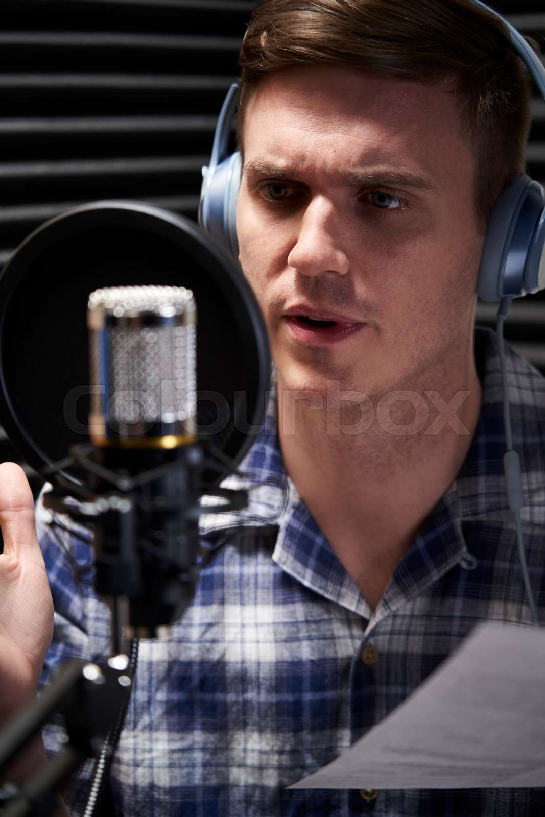 Male Voiceover Artist In Recording Studio Talking Into Microphone ...