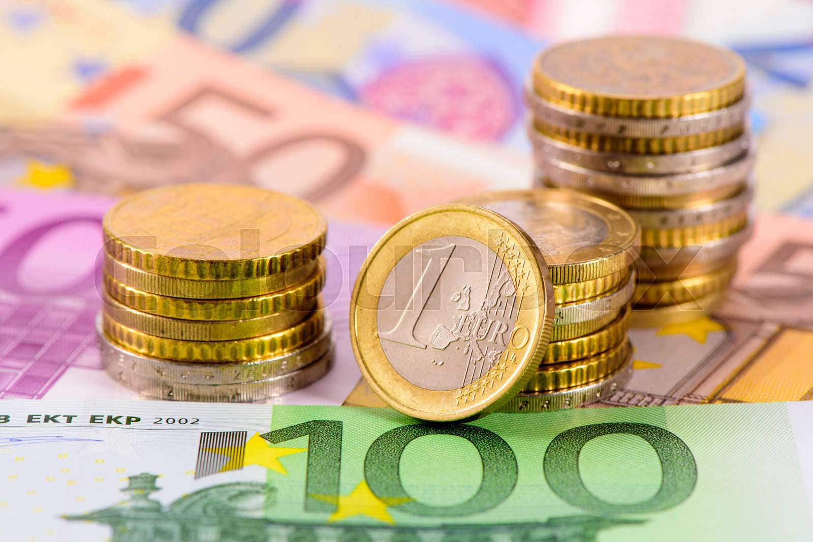 heap of banknotes of Euo currency with coins | Stock image | Colourbox