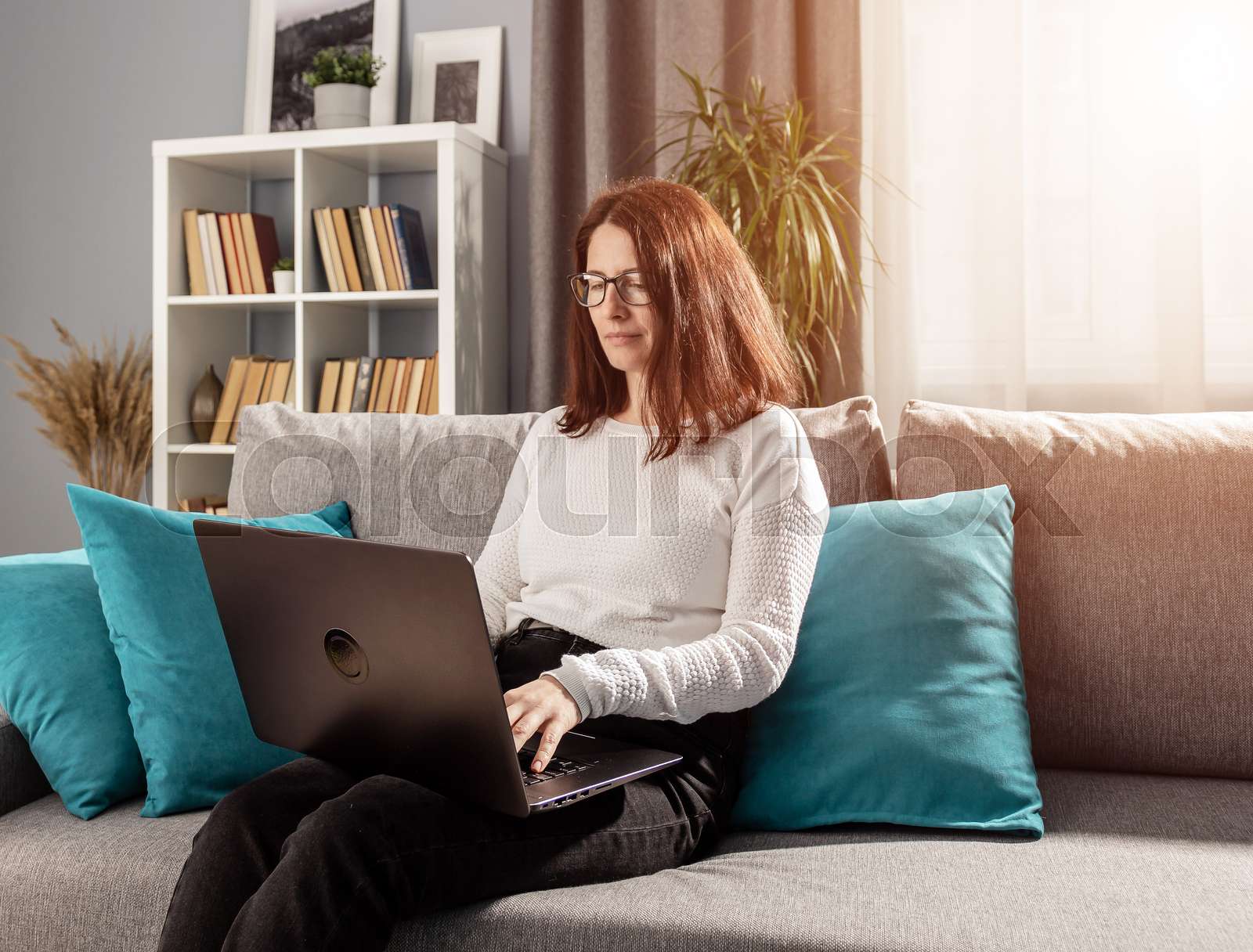 Middle-aged woman working from home | Stock image | Colourbox