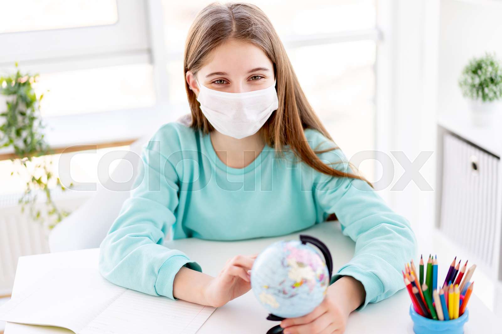 Cute girl schooling at home | Stock image | Colourbox