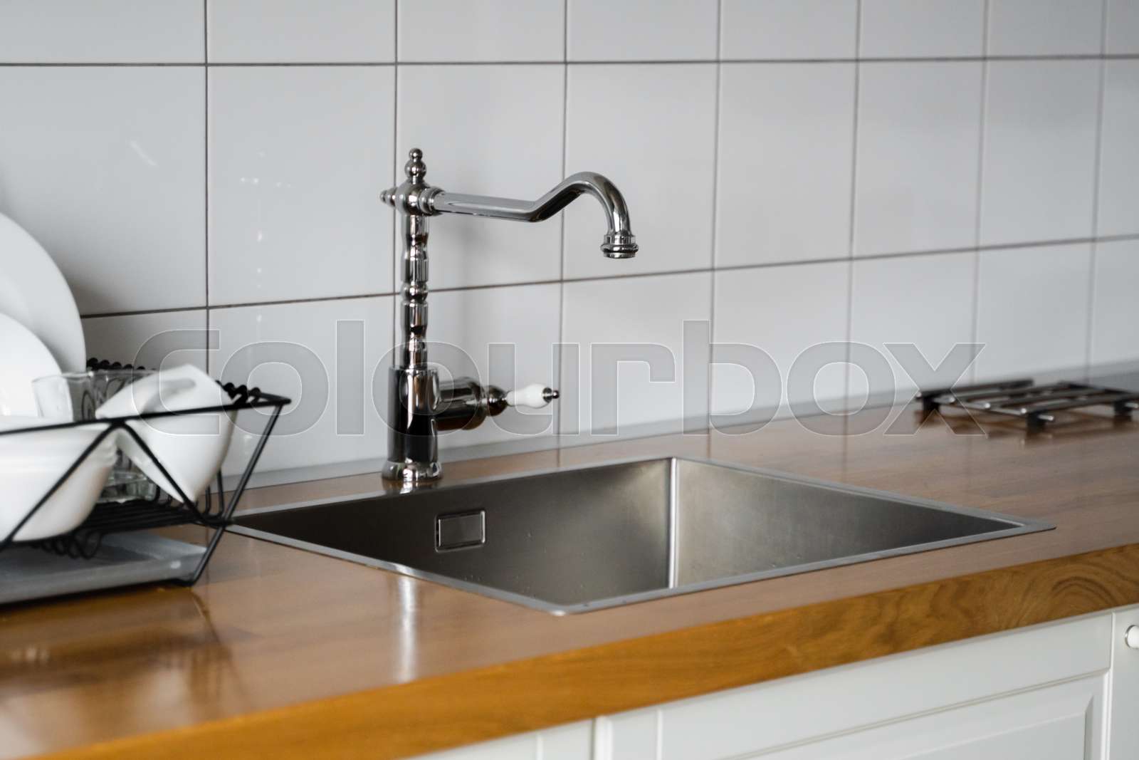 Kitchen sink and faucet. Stainless kitchen sink and tap water. The ...