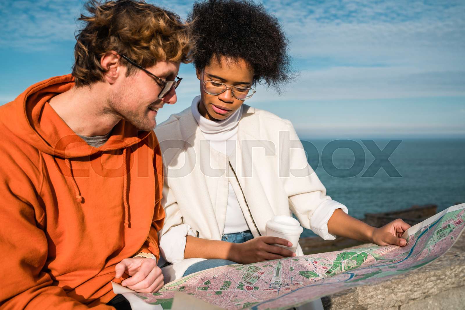 Two travelers with a map. | Stock image | Colourbox