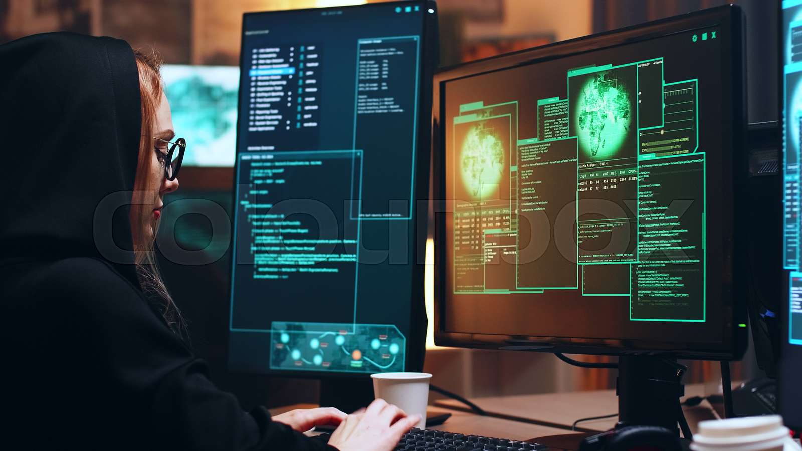 Girl hacker sitting at her super computer | Stock image | Colourbox