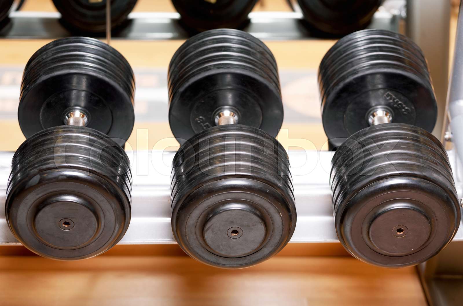 Different sizes and weights of dumbbell free weights at a gym. | Stock ...