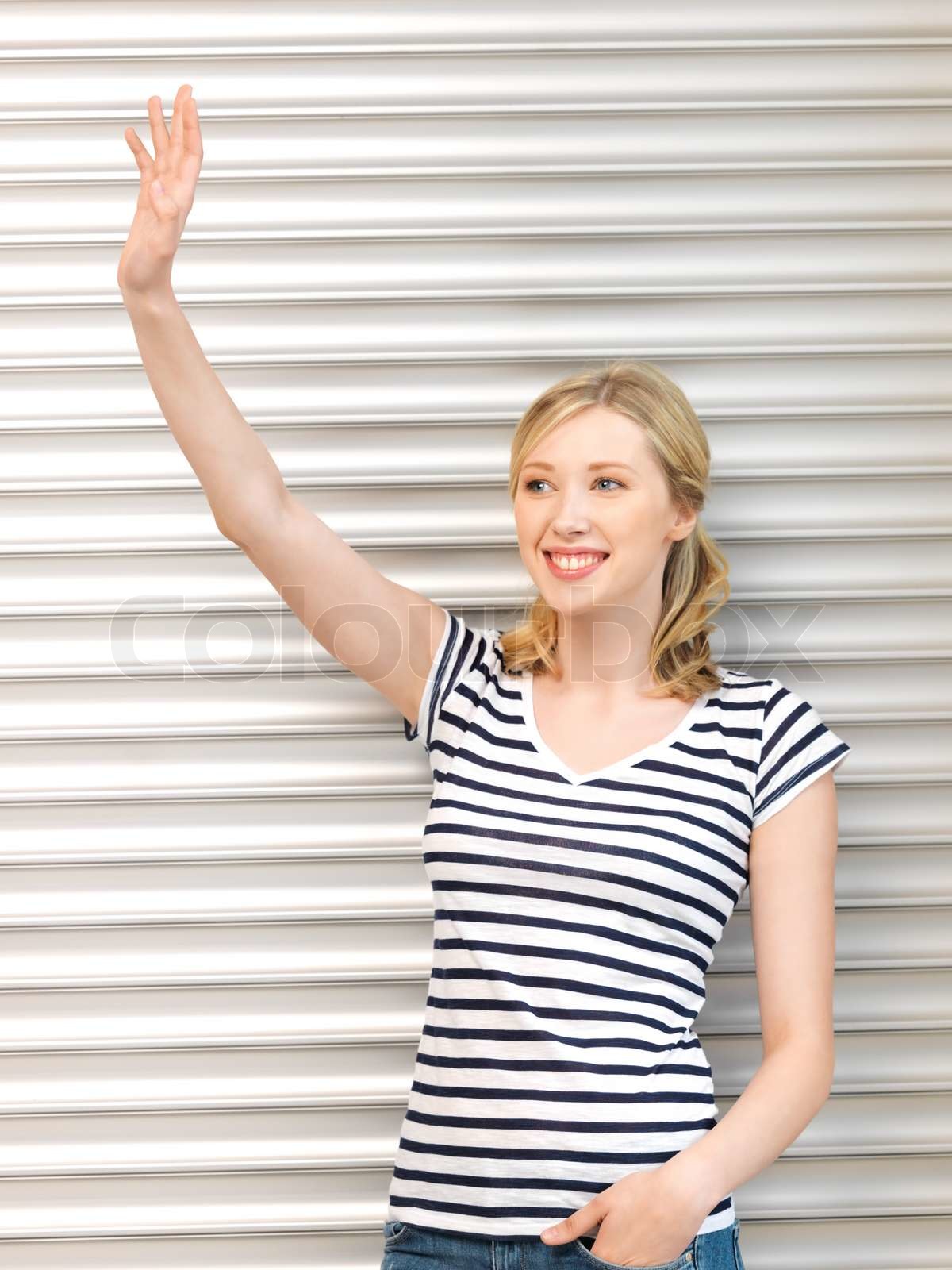 happy teenage girl waving a greeting | Stock image | Colourbox