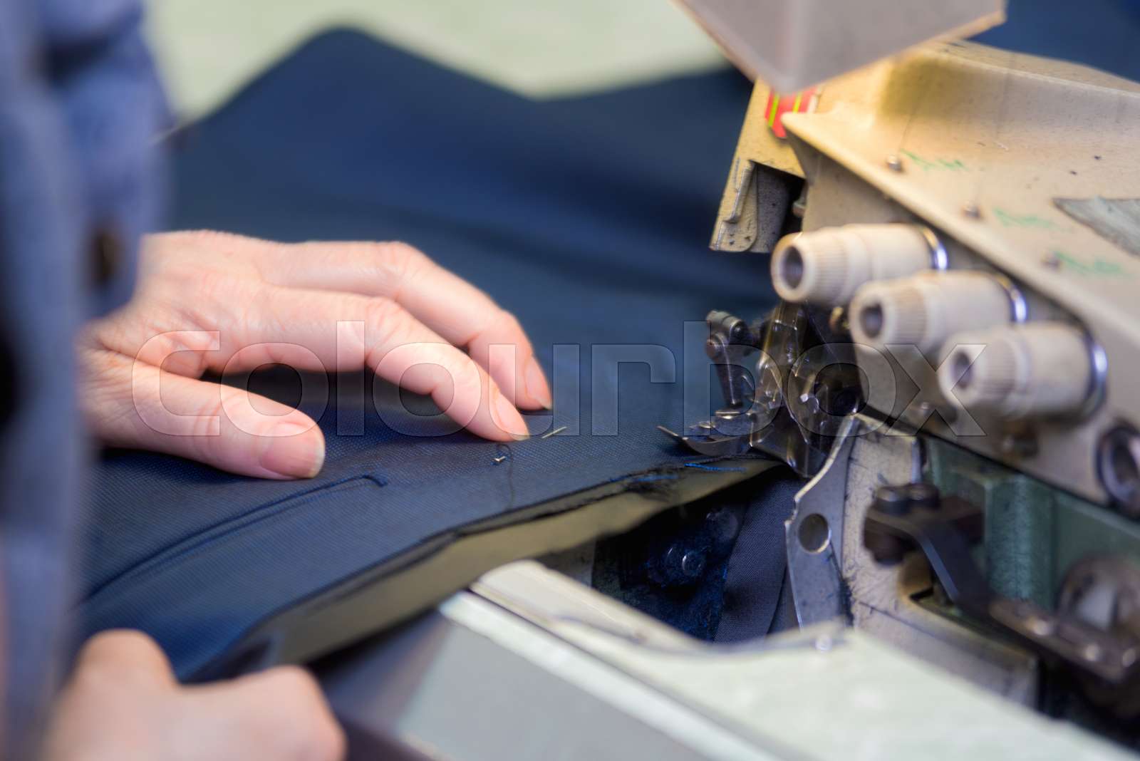 Seamstress sews clothes on a sewing machine. Textile factory. | Stock ...