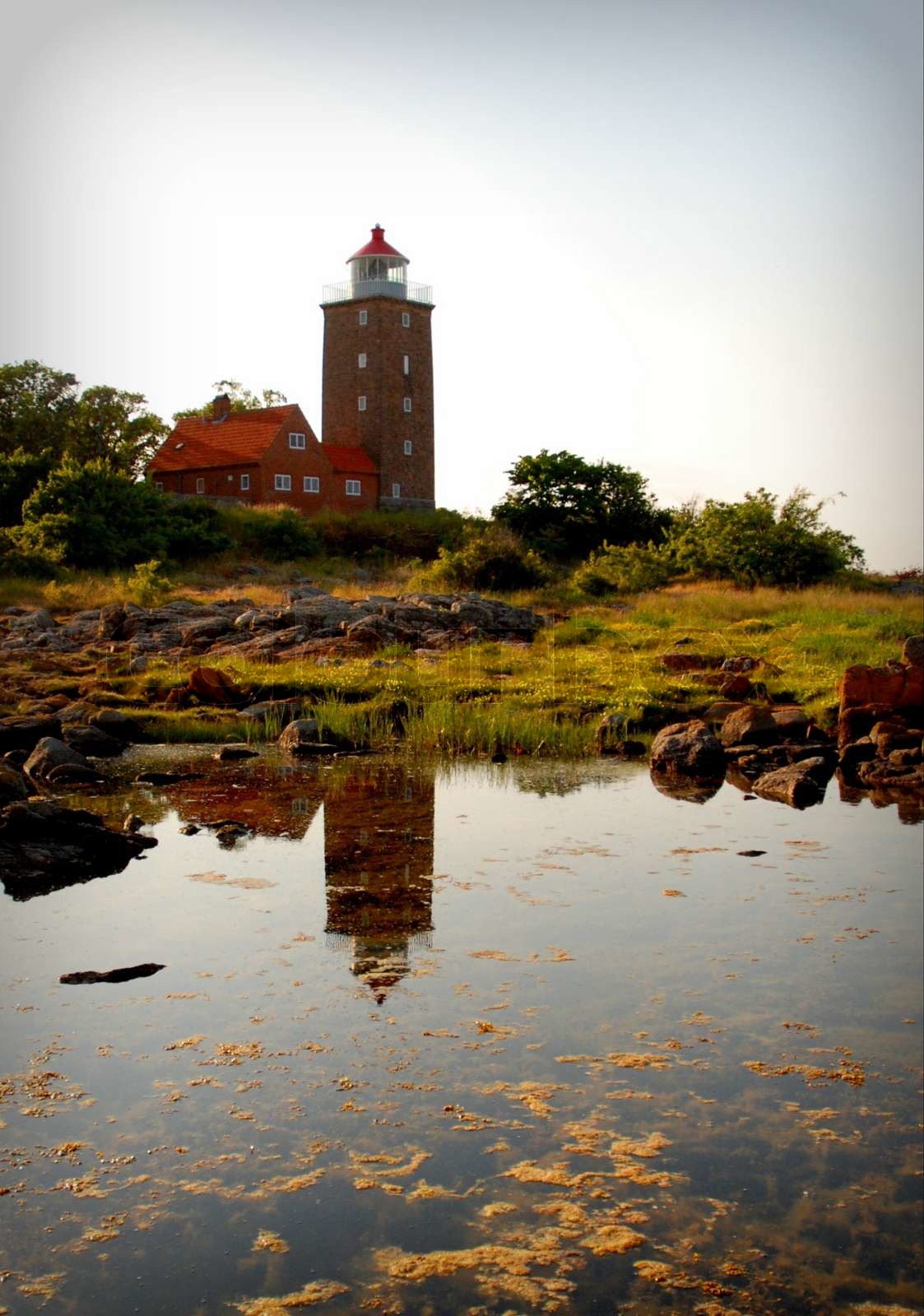 Svaneke Lighthouse Reflecting into the Sea | Stock image | Colourbox