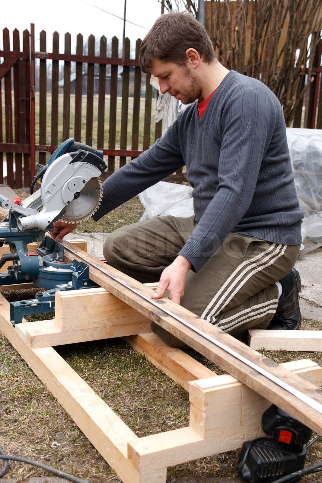 Carpenter cutting wooden plank | Stock image | Colourbox